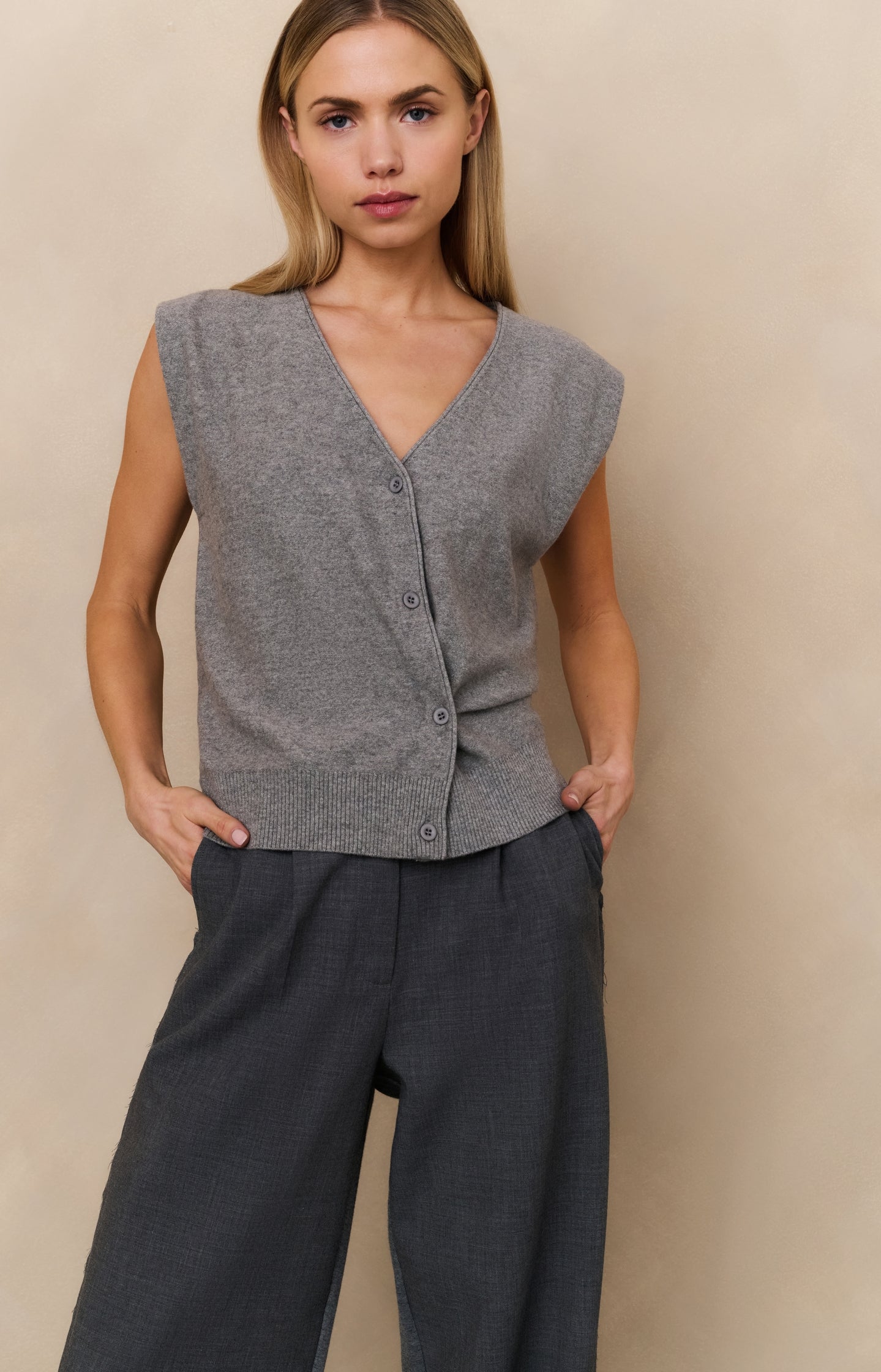 Knitted gilet with V-neck and asymmetric buttoning