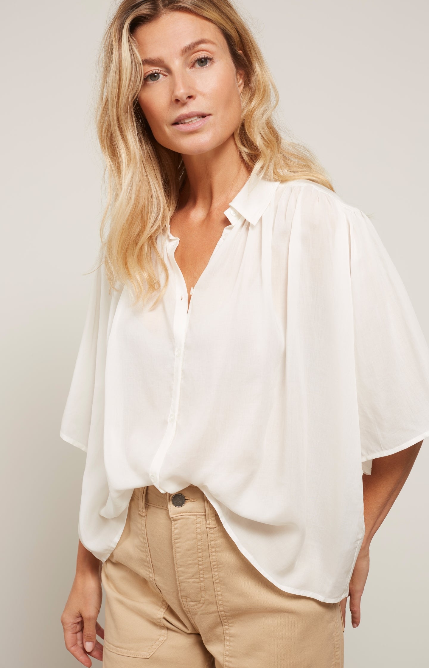 Oversized blouse with wide sleeves and pleated details