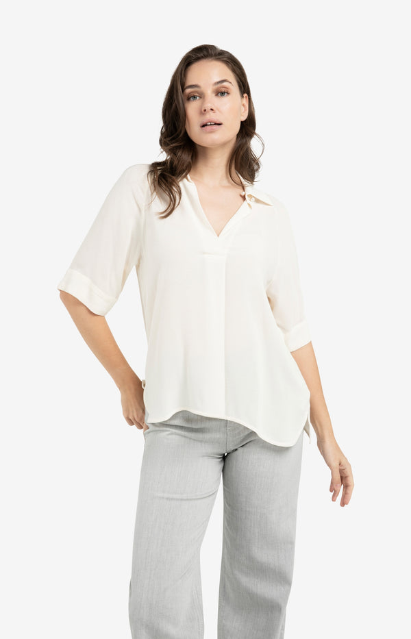 Top with short raglan sleeves and pearl detail